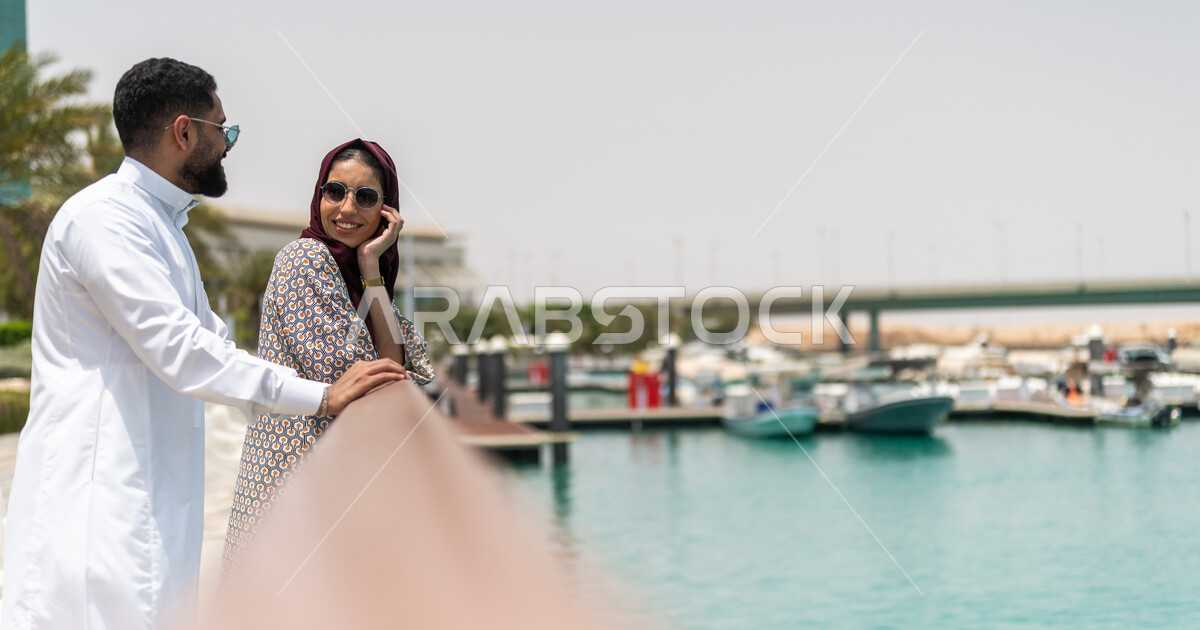 A Saudi Arabian Gulf couple in the Jeddah Corniche promenade, enjoying ...