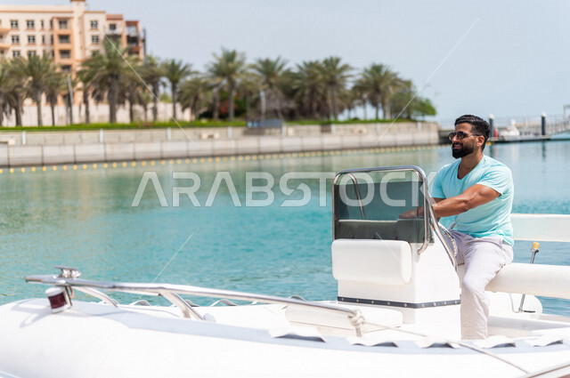 A Saudi Arabian Gulf man on a yacht in the middle of the sea, the ...