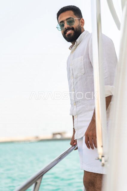 A young Saudi Arabian Gulf man on a yacht in the sea, the pleasure of ...