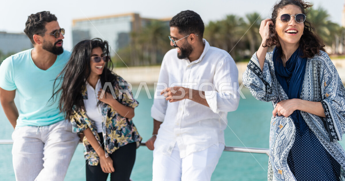 A group of Saudi Arabian Gulf friends on board a yacht, meeting friends ...