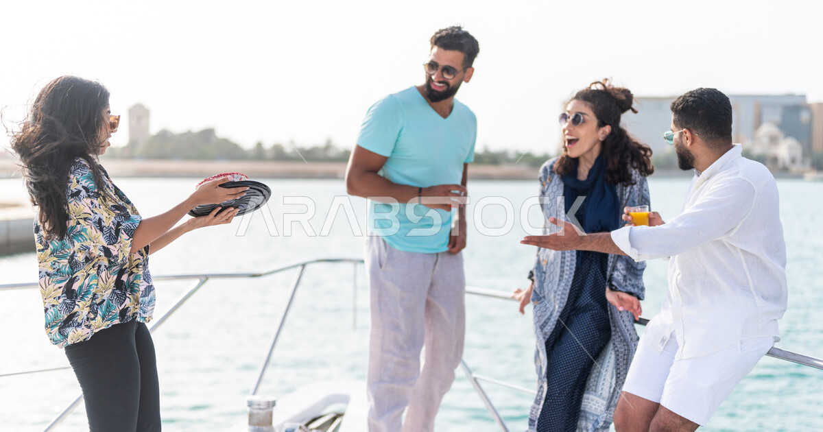 A group of Saudi Arabian Gulf friends celebrate on board a yacht ...