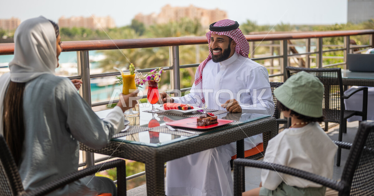 A Saudi Arabian Gulf family spending a good time together, enjoying ...