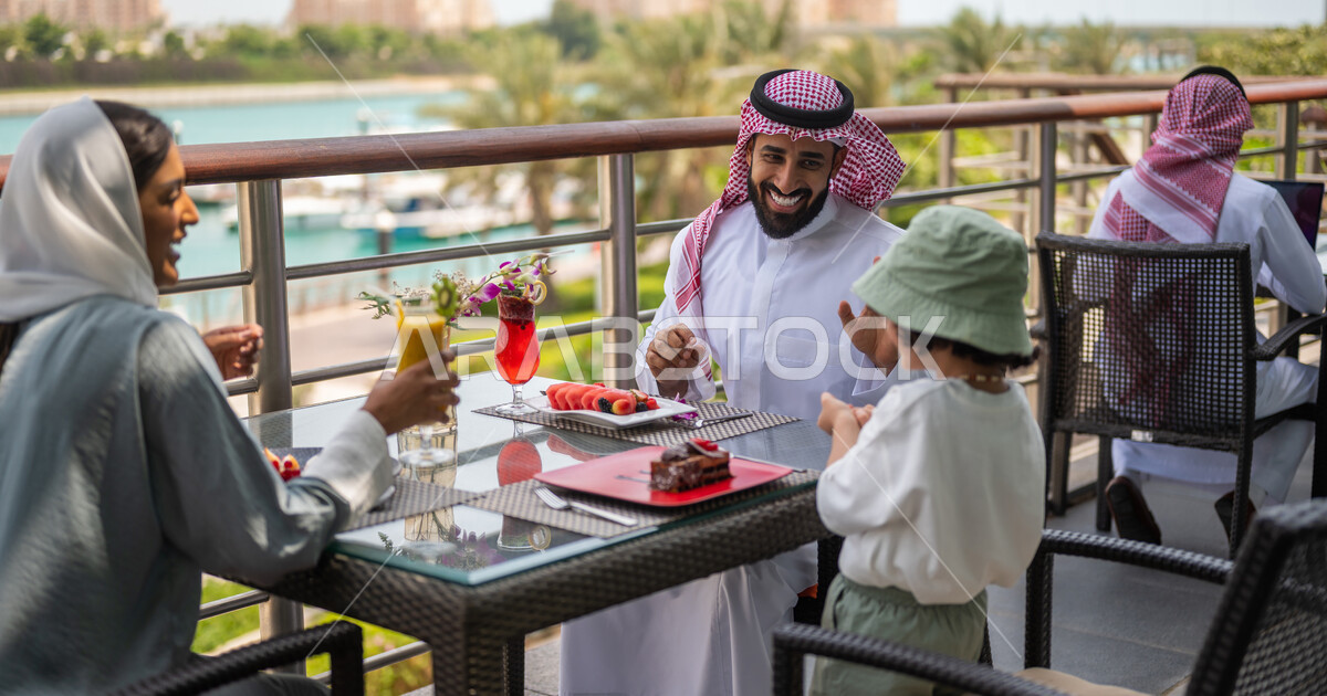A Saudi Arabian Gulf family spending a good time together, enjoying ...