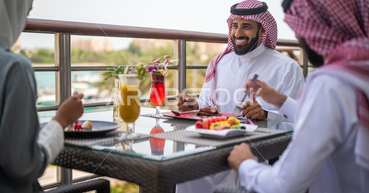 A group of Saudi Arab Gulf friends in a fun time together, enjoying ...