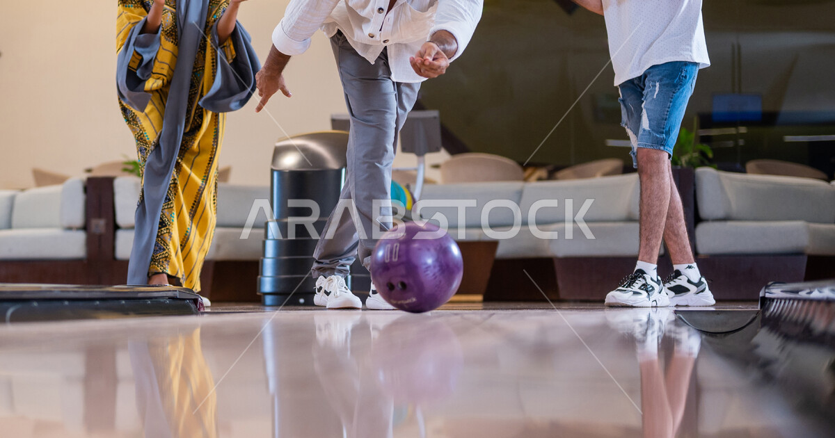 A group of Saudi Arabian Gulf friends practicing the game of bowling ...