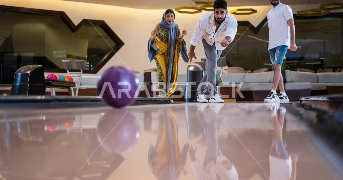 A group of Saudi Arabian Gulf friends practicing the game of bowling ...