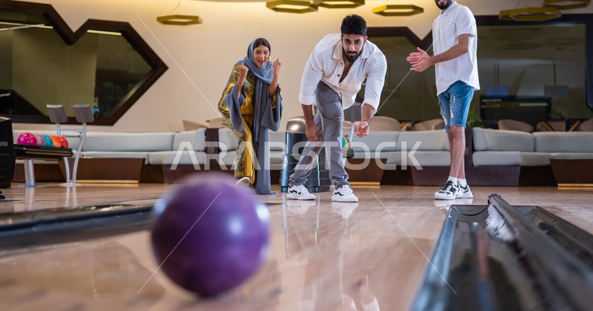 A group of Saudi Arabian Gulf friends practicing the game of bowling ...