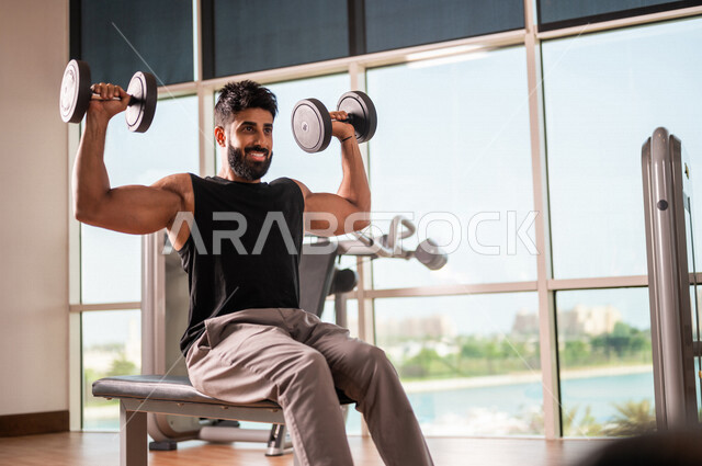 A Saudi Arabian Gulf man wears sports clothes and exercises, uses ...