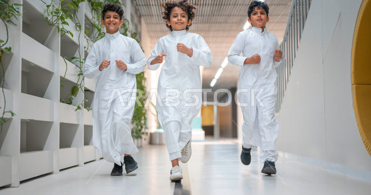 Saudi Arabian Gulf students running in the school hall, playing and ...
