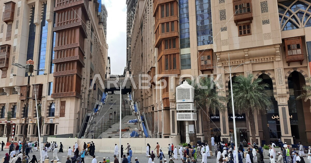 A group of tourists in the streets surrounding the towers of Jabal Omar ...