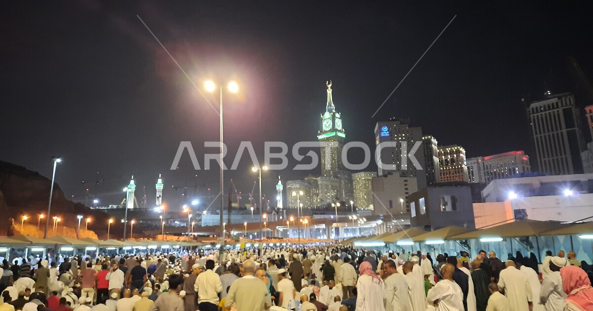 A group of visitors to the House of God sitting in the streets of Mecca ...