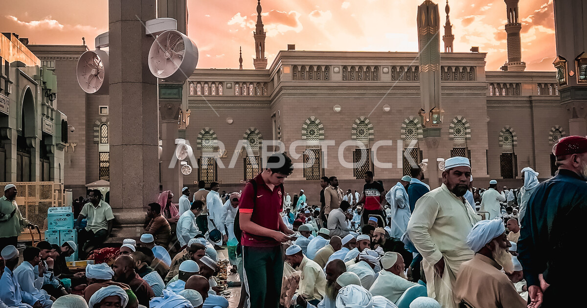 A group of Muslims sitting at the collective breakfast table in the ...