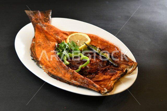 Close-up of the delicious grilled fish dish, traditional Arab food ...