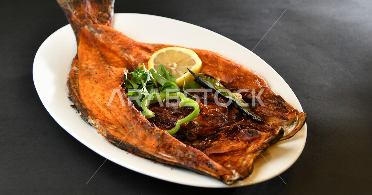 Close-up of the delicious grilled fish dish, traditional Arab food ...