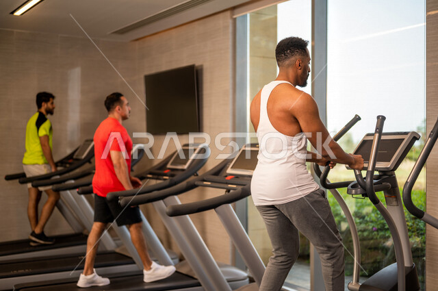 A group of Saudi Arabian Gulf youth wearing sports clothes in the gym ...