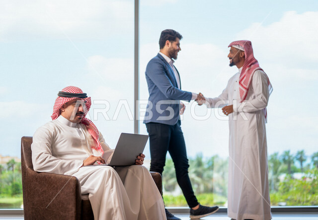 A Saudi team and a man in a formal suit in the meeting room inside the ...