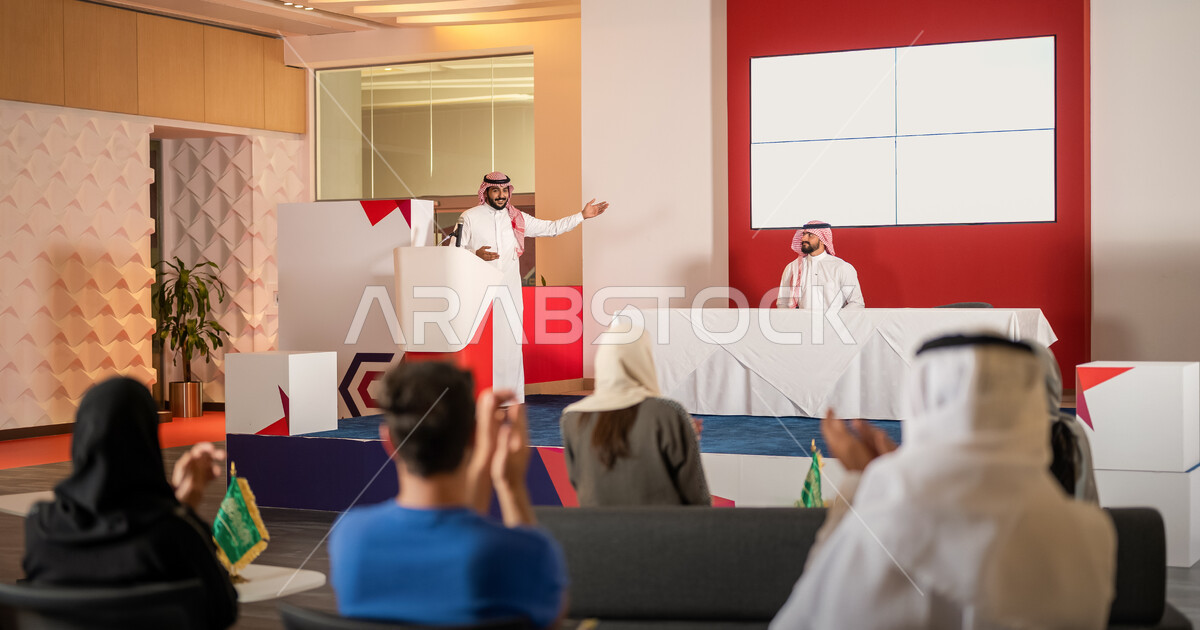 A picture from the back of a group of Saudi Arabian Gulf employees in a ...