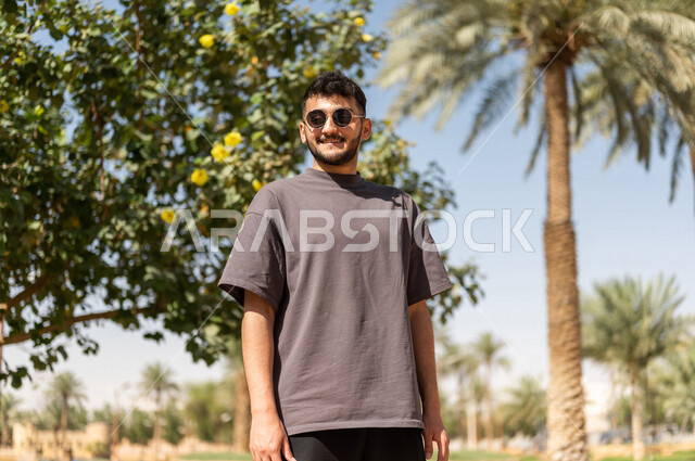 A close-up of a young Saudi Arabian Gulf man wearing sunglasses ...