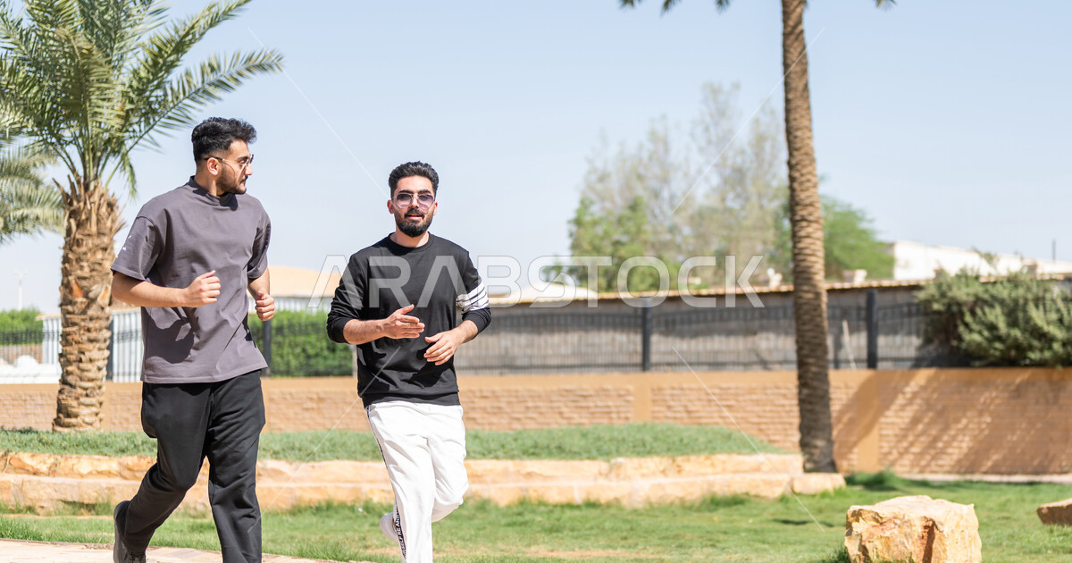 Two Saudi Arab Gulf friends practicing jogging, health and physical ...