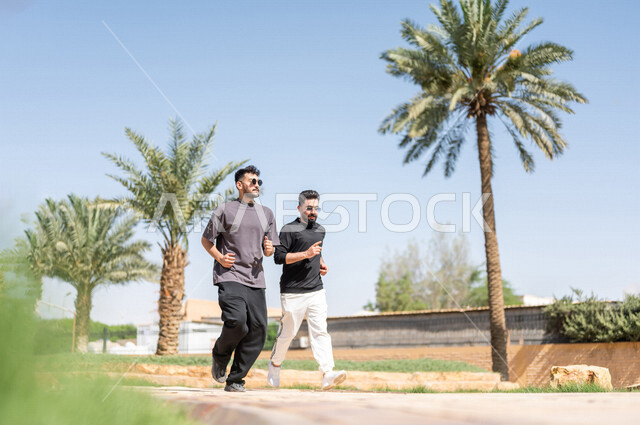 Two Saudi Arab Gulf friends practicing jogging, health and physical ...
