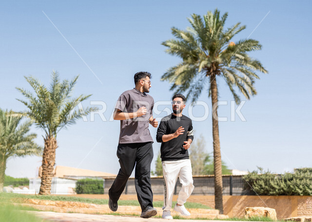 Two Saudi Arab Gulf friends practicing jogging, health and physical ...