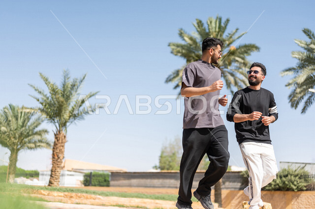 Two Saudi Arab Gulf friends practicing jogging, health and physical ...