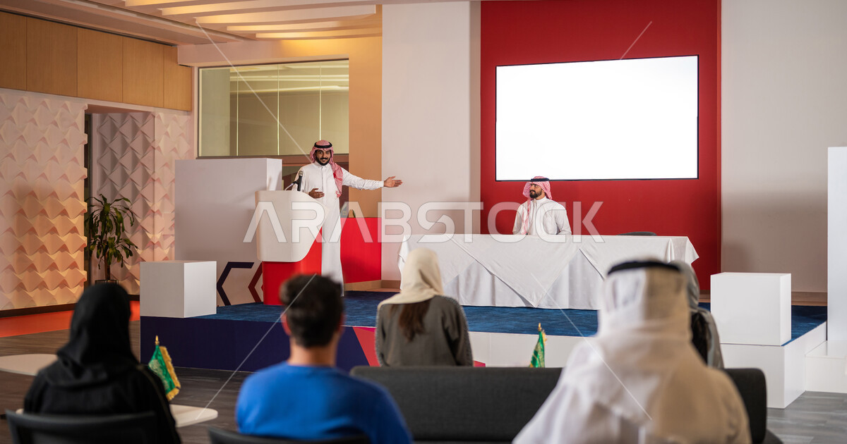 A picture from the back of a group of Saudi Arabian Gulf employees in a ...