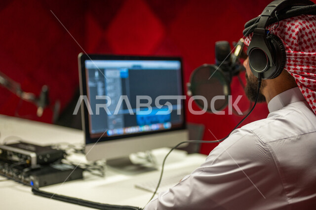 A close-up of the back of a Saudi Arabian Gulf radio reporter in the ...