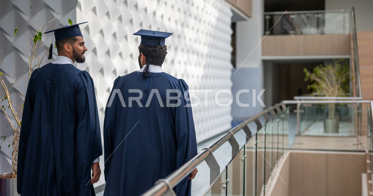 A picture from the back of two Saudi Arabian Gulf students wearing the ...