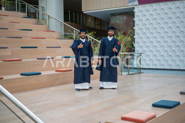 Two Saudi Arabian Gulf students wearing the abaya and graduation cap ...
