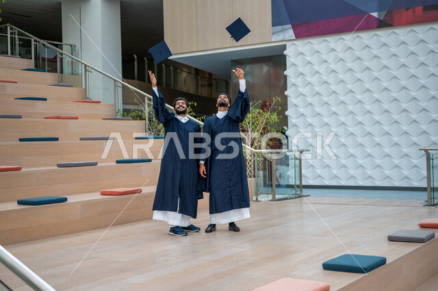 Two Saudi Arabian Gulf students wearing an abaya and graduation cap ...
