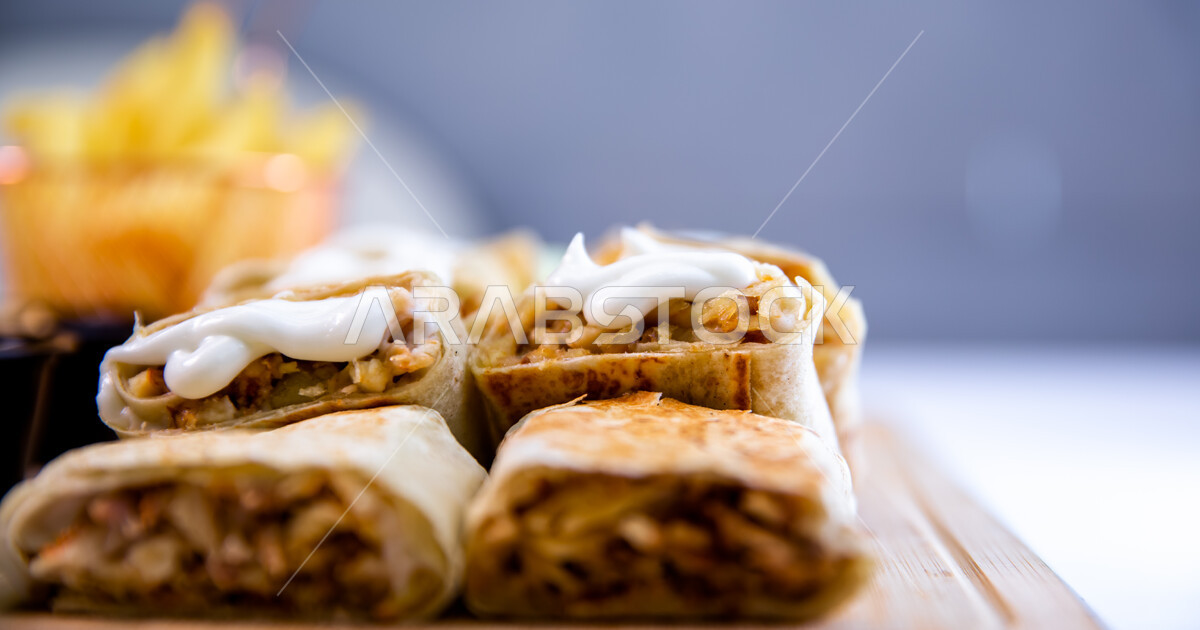 Close-up of delicious chicken shawarma sandwich with french fries ...