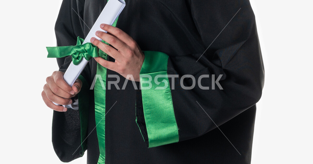 Portrait of a Saudi Arabian Gulf student wearing a gown and graduation ...