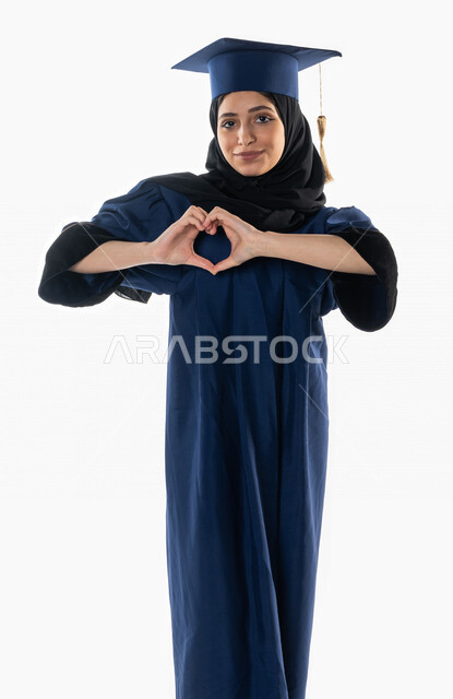 Portrait of a Saudi Arabian Gulf student wearing an abaya and graduation cap, palms forming in ...
