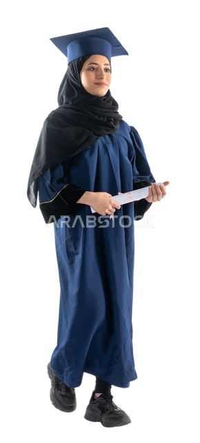 Portrait of a Saudi Arabian Gulf student wearing an abaya and graduation cap, holding a ...