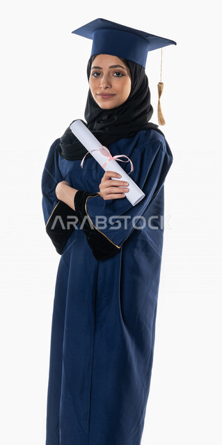 Portrait of a Saudi Arabian Gulf student wearing an abaya and graduation cap, holding a ...