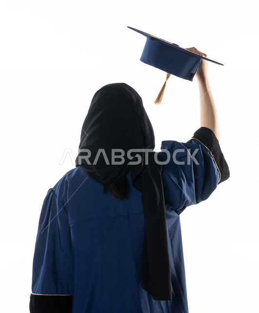Portrait from the back of a Saudi Arabian Gulf student wearing an abaya and graduation cap ...