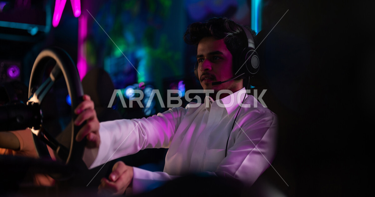 A close-up of a Saudi Arabian Gulf youth in an electronic game store, a ...