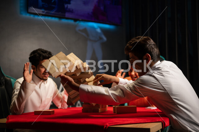 A close-up of a group of young Saudi Arabian Gulf teenagers playing ...