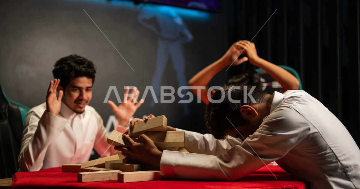 A close-up of a group of young Saudi Arabian Gulf teenagers playing ...