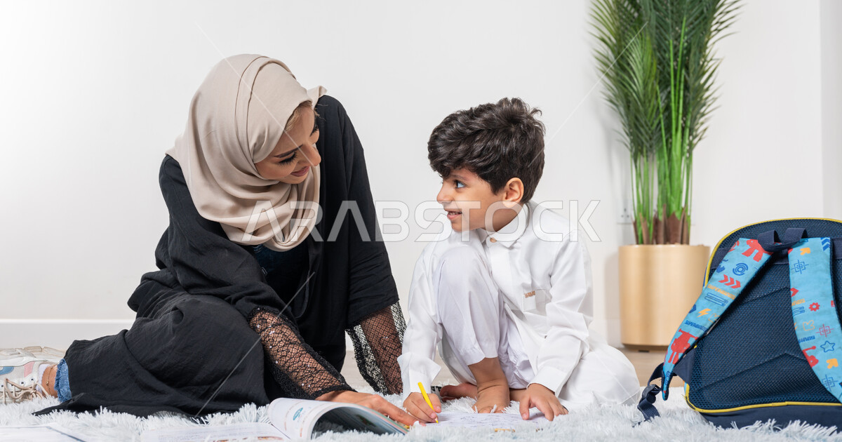 A Saudi Gulf Arab mother helps her child learn at home, educational ...