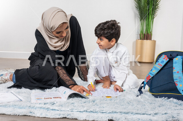 A Saudi Gulf Arab mother helps her child learn at home, educational ...