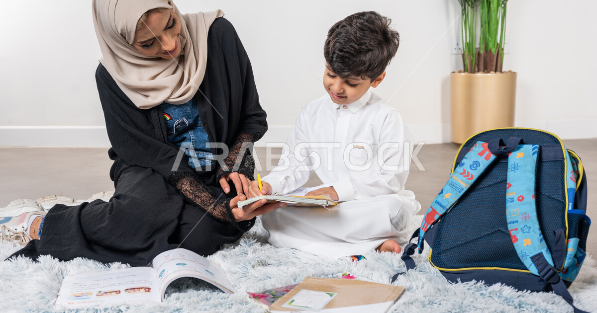 A Saudi Gulf Arab mother helps her child learn at home, educational ...