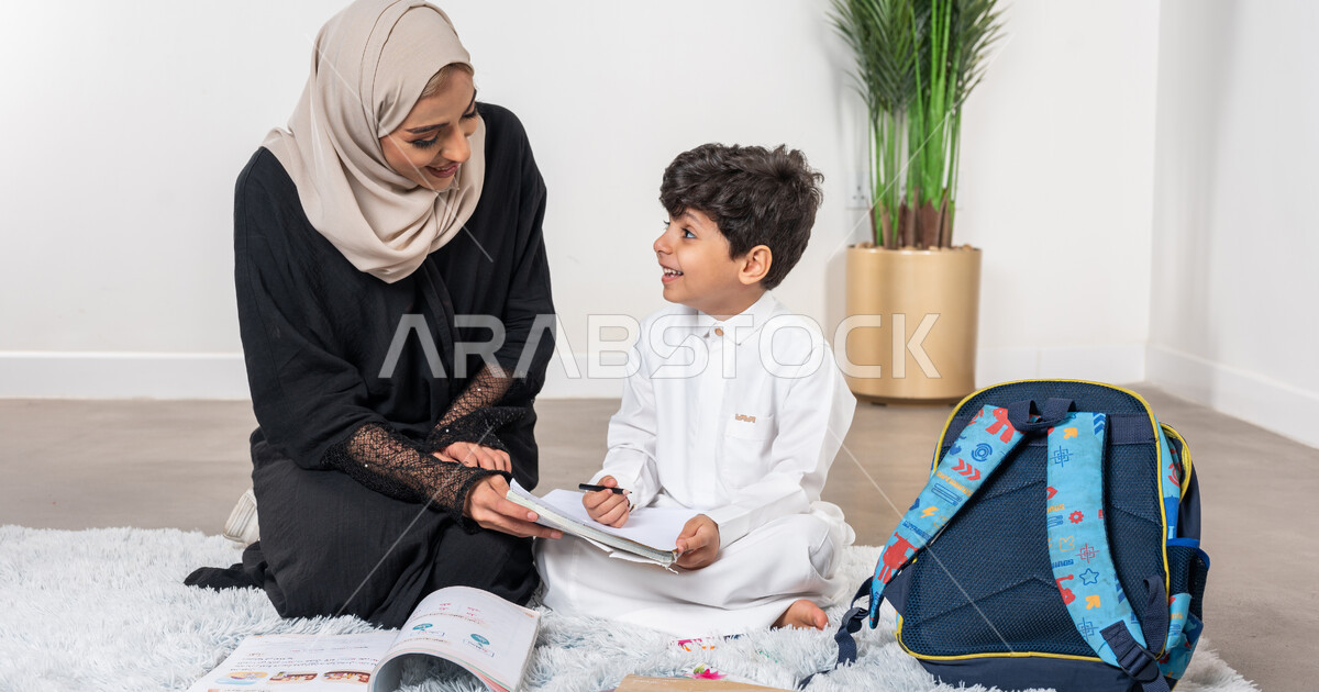 A Saudi Gulf Arab mother helps her child learn at home, educational ...
