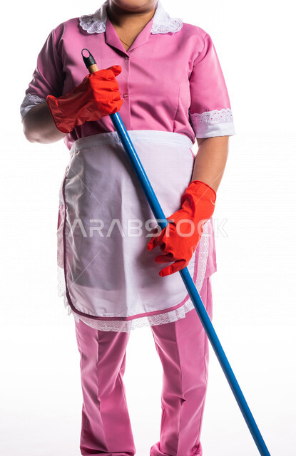 Close-up portrait of a cleaning lady wearing gloves and apron, holding ...