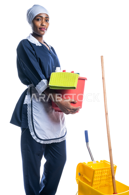 Portrait of a cleaning lady wearing an apron, holding a bucket of ...