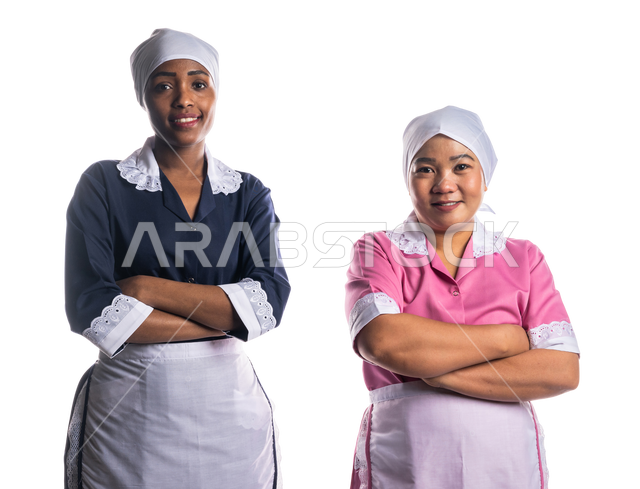 Portrait of two apron-wearing cleaners looking at the camera with ...