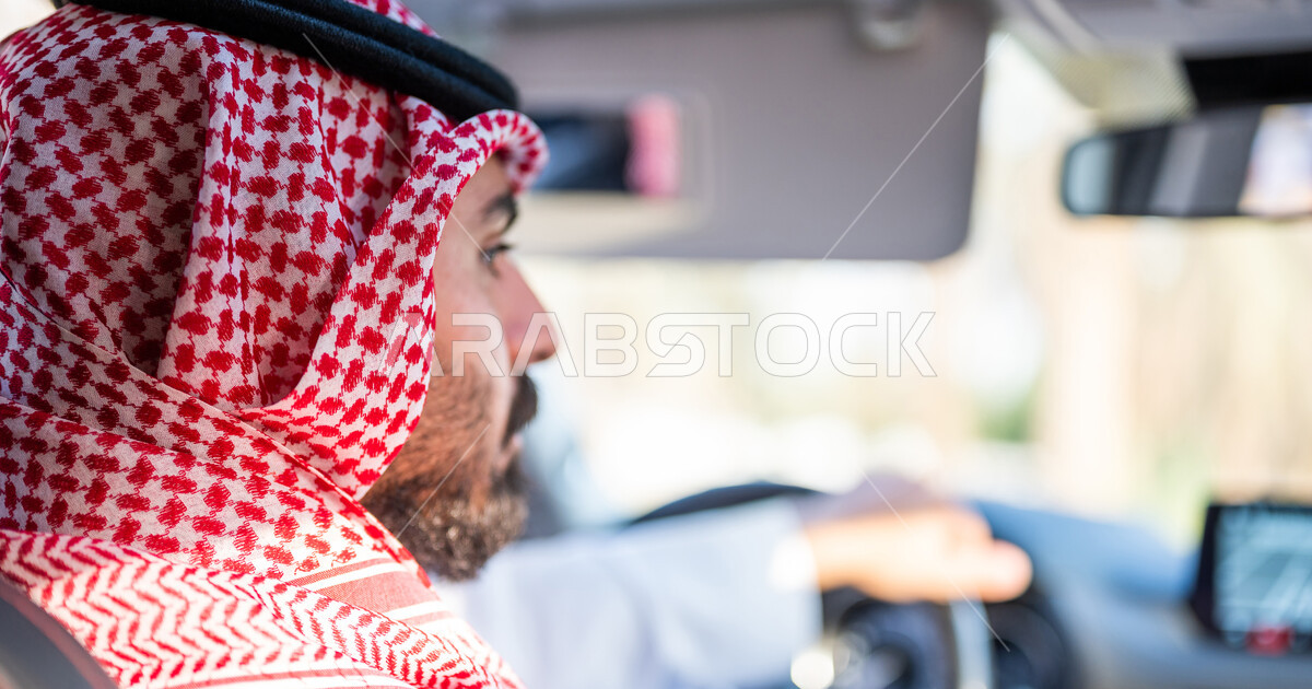 Close-up of a Saudi Arabian Gulf man driving the car, passenger ...