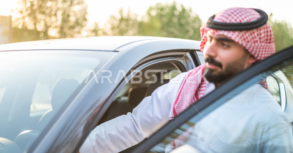 A Saudi Arabian Gulf man opens the car door, prepares to board the car ...