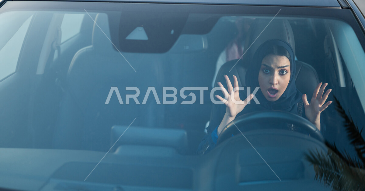 A veiled Saudi Arabian Gulf woman driving a car, freedom to drive for ...